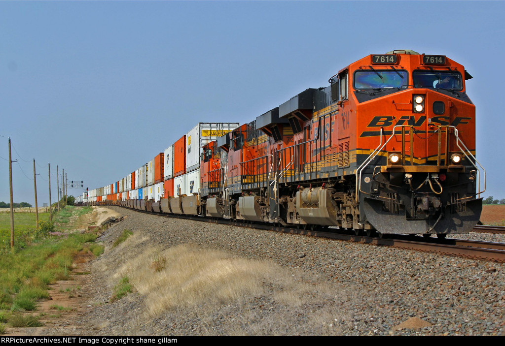 BNSF 7614 rips a EB stack train thur the small town of millian ks.